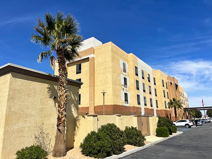 The Hampton Inn stands as a modern oasis for weary travelers, its earth-toned exterior blending with the desert palette like architectural camouflage.