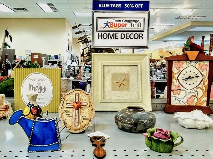 Home décor treasures arranged with care. That blue watering can is just begging to become someone's whimsical indoor planter.