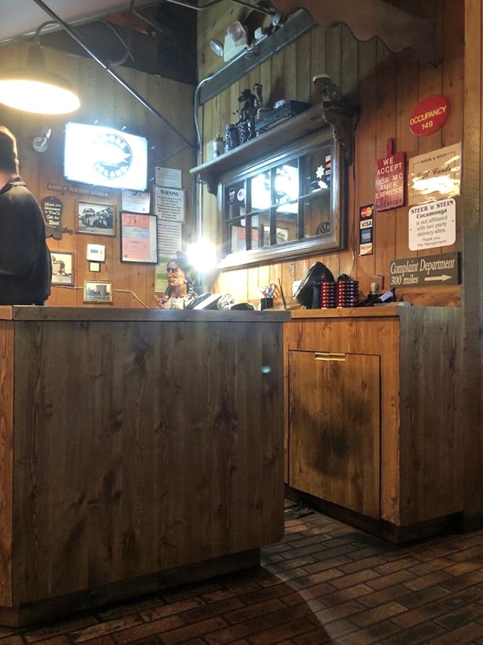 The host station—wood-paneled and welcoming—where your journey into steak nirvana officially begins with a friendly greeting.
