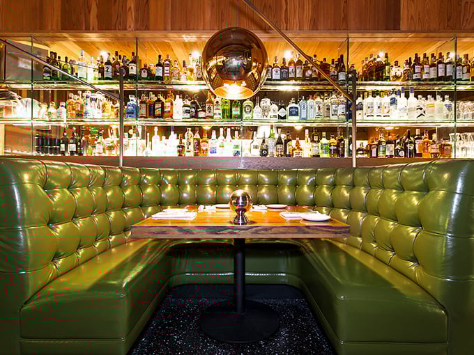 This booth isn't just seating—it's a private sanctuary where important decisions are made, like whether to order a second cocktail.