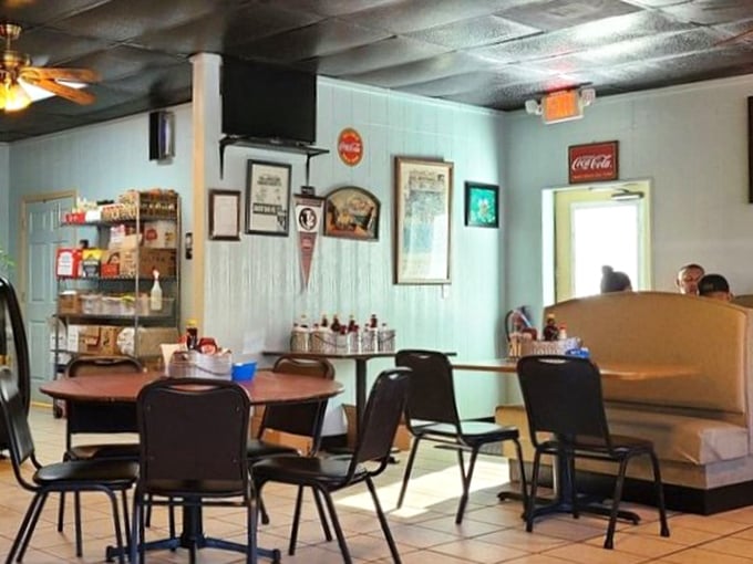 Classic diner decor where Coca-Cola signs and ceiling tiles create the perfect backdrop for comfort food magic.