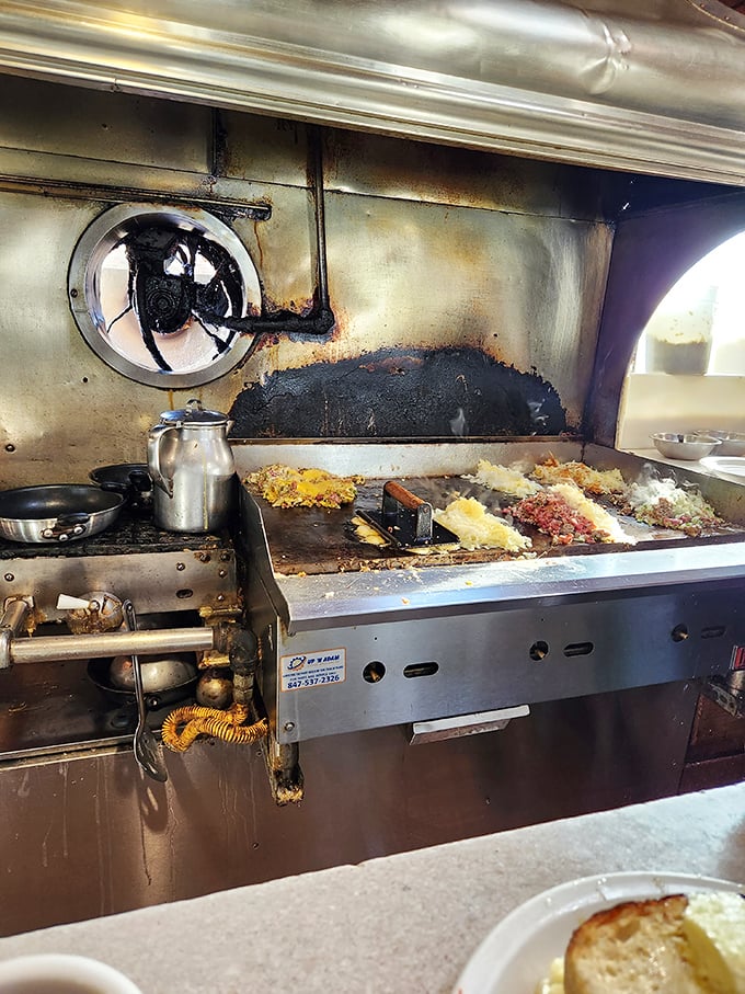 The well-seasoned flattop—where breakfast dreams come true and diet plans go to die. That patina isn't grime; it's a century of flavor development.