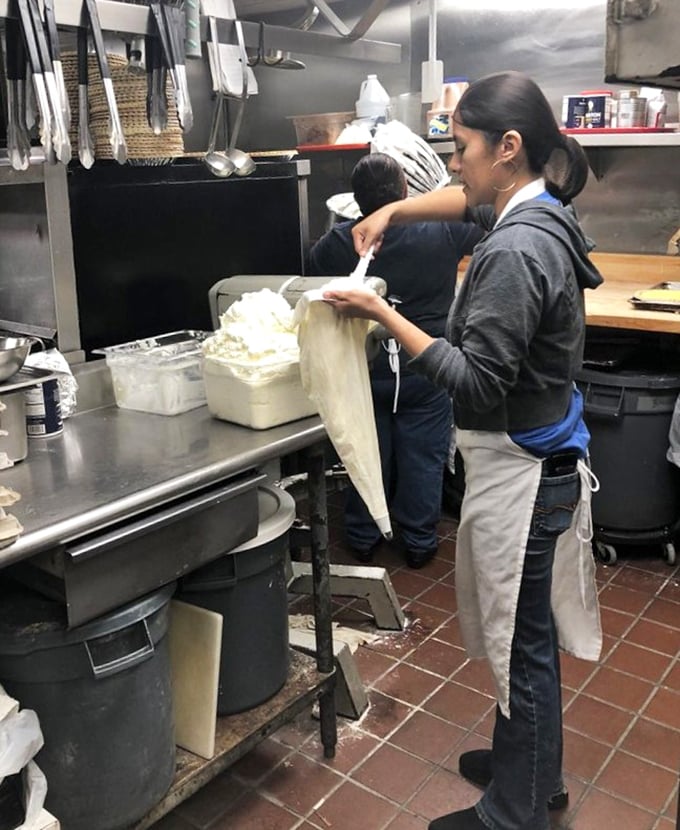 Behind the scenes, skilled hands prepare the legendary pies. That meringue doesn't whip itself into those perfect peaks!