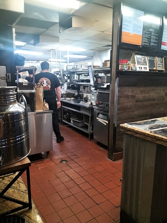 Behind the scenes where smoke and fire transform ordinary cuts into extraordinary experiences. The magic happens on those stainless steel surfaces.