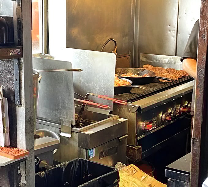 A glimpse into the kitchen where burger magic happens—no fancy equipment, just well-seasoned grills and decades of know-how.