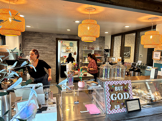 The bustling heart of brunch operations—where magic happens under woven pendant lights while pastries tempt from behind glass.