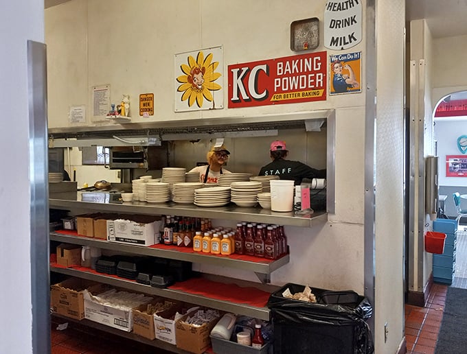 Behind the scenes magic where plates emerge like works of art, under the watchful eye of vintage advertisements.