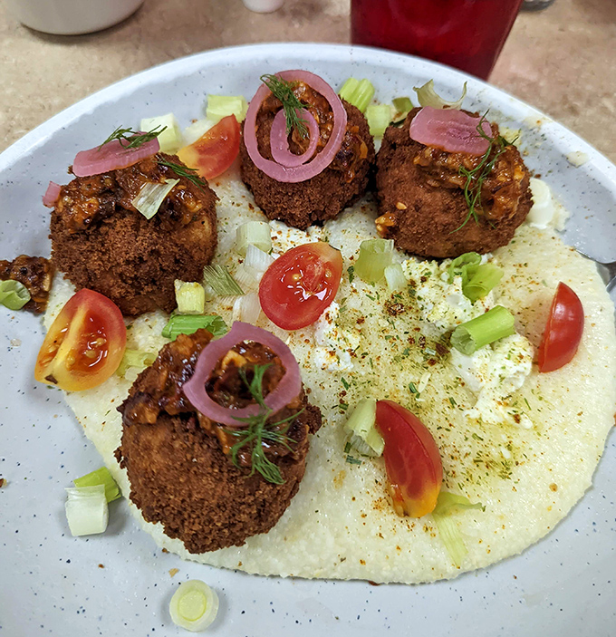 These aren't your grandma's grits—unless your grandma topped hers with seasoned meatballs, pickled onions, and fresh herbs.