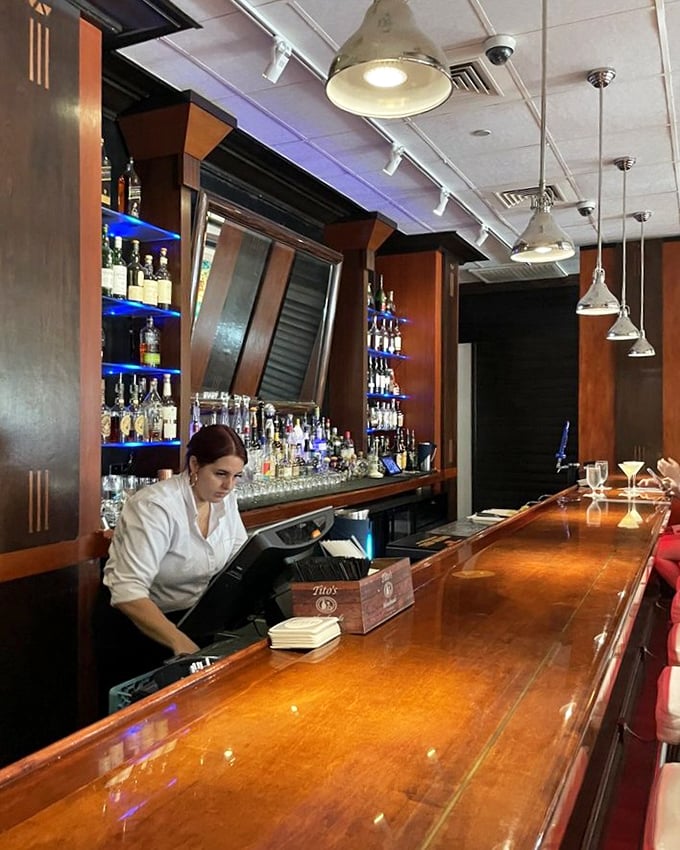 A bar that understands the gravity of proper cocktail preparation. That polished wood has heard more food confessions than a culinary priest.