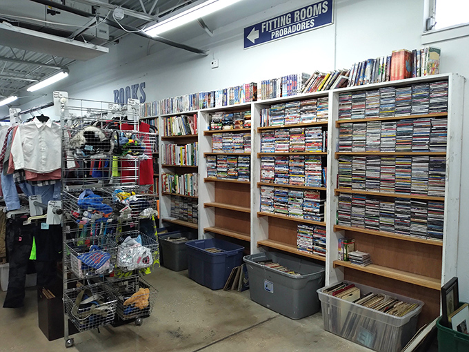 The media section – where forgotten DVDs, paperbacks, and video games await their cultural renaissance in someone's living room.