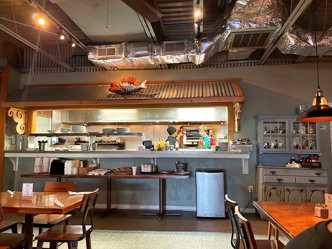 The open kitchen isn't just for show—it's a stage where seafood becomes the star. That corrugated metal awning adds just the right touch of coastal charm.