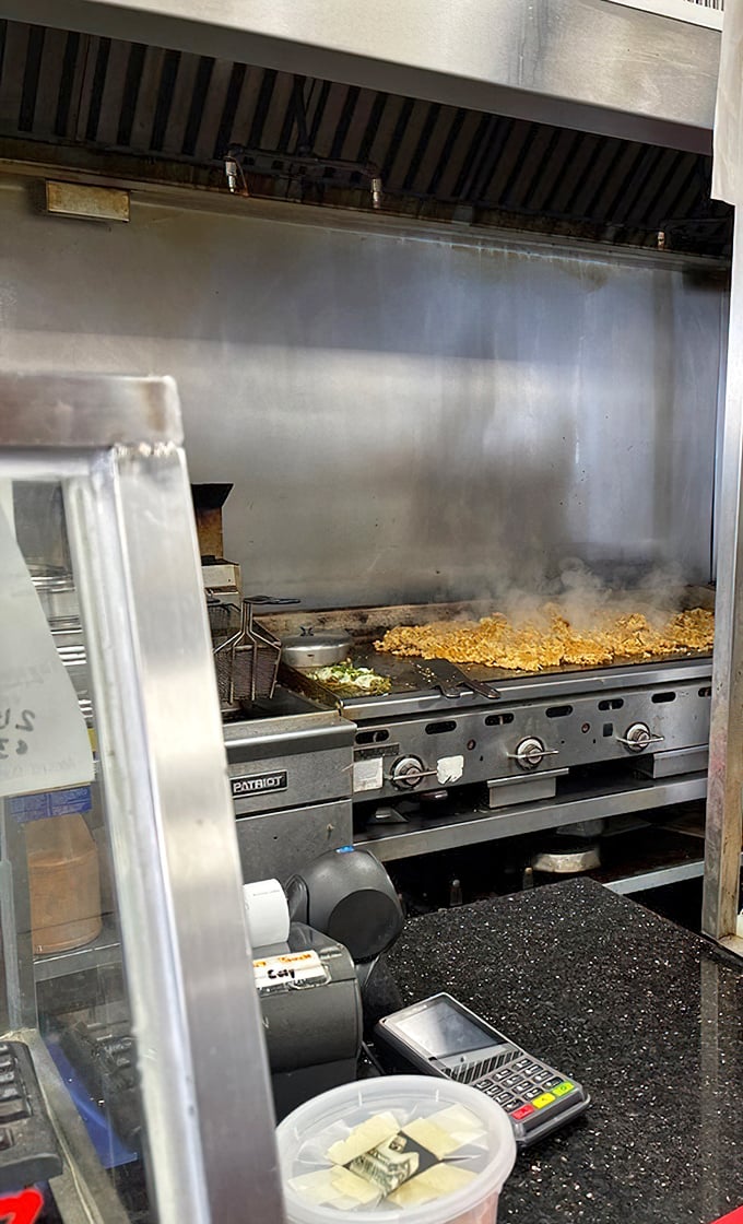Where the magic happens: sizzling meat on the flattop, the heartbeat of any serious cheesesteak operation.
