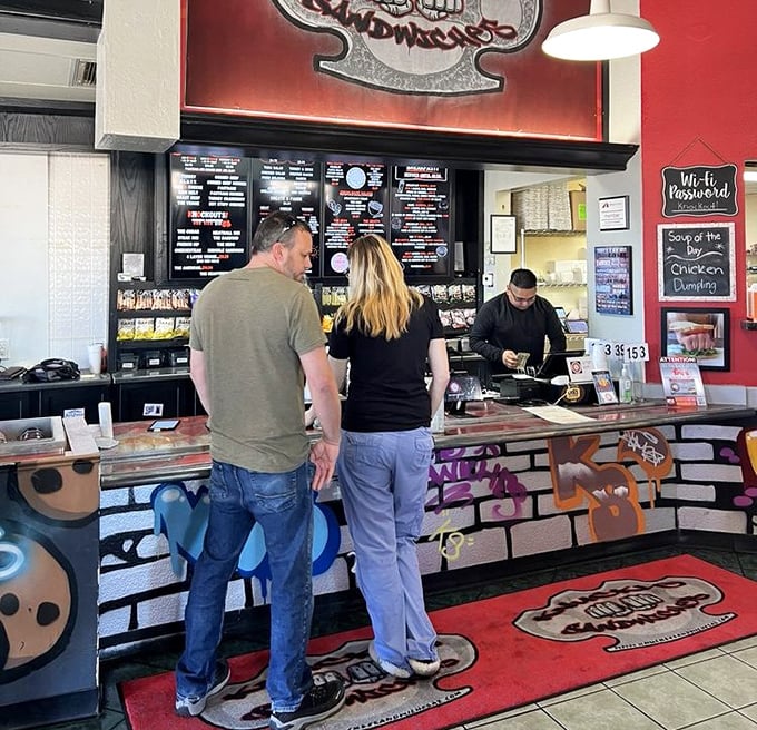 The moment of decision at the counter—where friendly staff stand ready to transform your hunger into happiness with boxing-themed culinary creations.