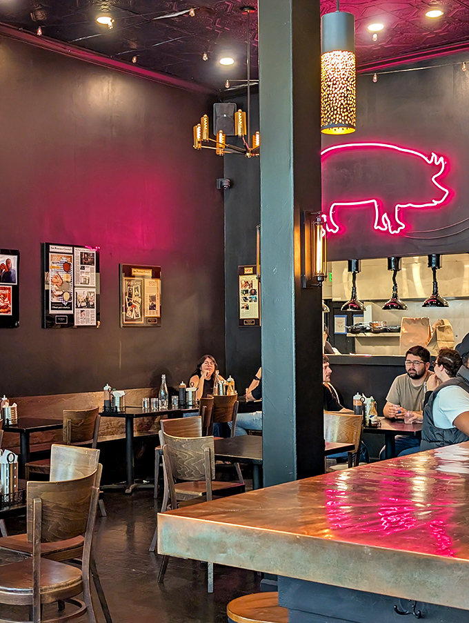 The pink neon pig sign isn't just decoration—it's a beacon of hope for hungry souls seeking salvation through smoke and fire.