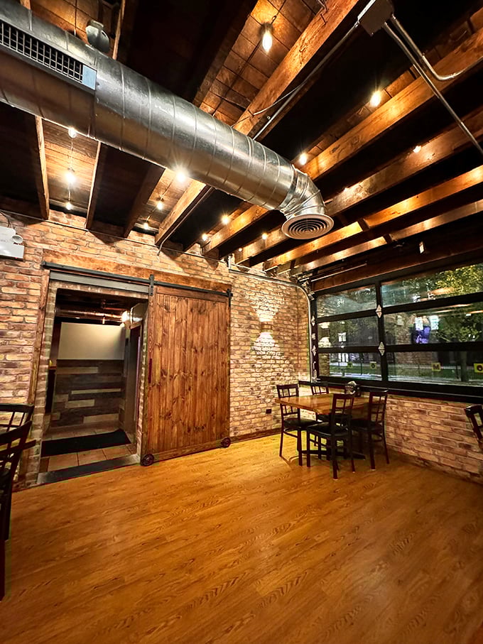 Exposed wooden beams and industrial ductwork create a space that feels both rustic and refined – the perfect backdrop for serious barbecue contemplation.