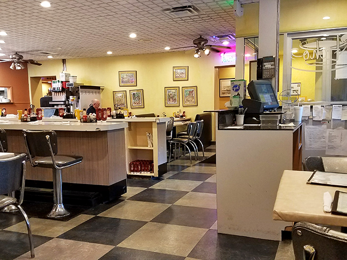 Yellow walls, ceiling fans, and cozy booths—the diner trifecta. This isn't interior design; it's a time machine to when conversations happened without screens.