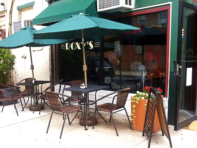 Outdoor seating under green umbrellas—because sometimes pancakes taste even better with a side of fresh air and people-watching.