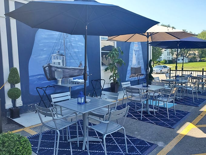 The outdoor seating area offers nautical vibes without the seasickness—those umbrellas are for sunshine, not sudden squalls.