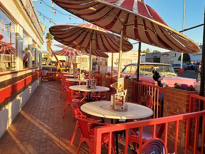 The outdoor patio with its candy-apple red furniture and striped umbrellas isn't just seating—it's Arizona sunshine with a side of people-watching perfection.