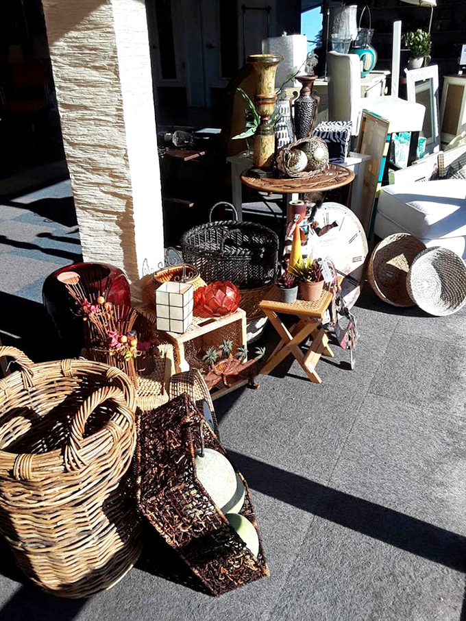 Sunlight bathes an eclectic collection of outdoor treasures—from wicker baskets to wooden stools—each with stories etched into their well-loved surfaces.