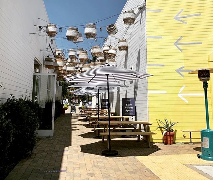 Outdoor dining under string lights with buoy decorations overhead—because seafood always tastes better when there's a hint of salt in the air and sun on your shoulders.