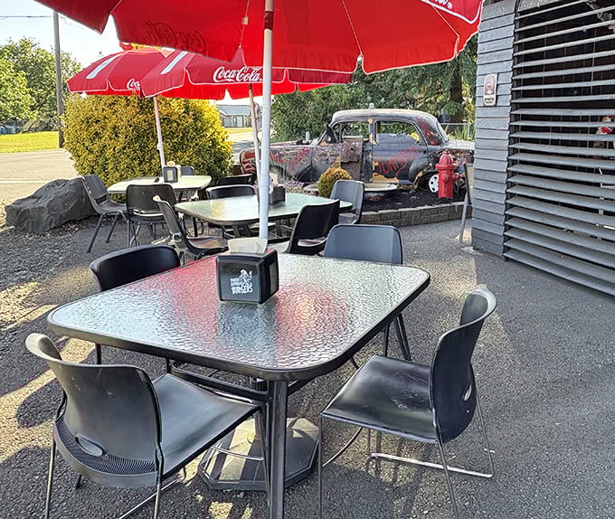 Outdoor dining with a side of automotive history – that vintage car isn't just decoration, it's part of the Junkyard's soul.
