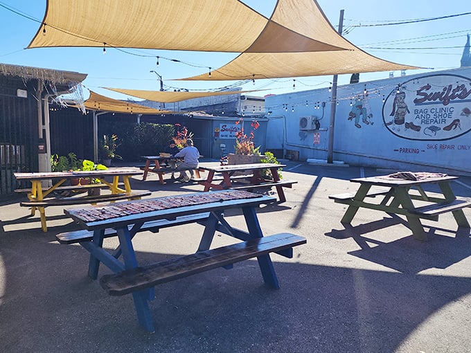 Outdoor picnic tables under sail shades – where you can pretend the calories don't count because you're technically dining al fresco.