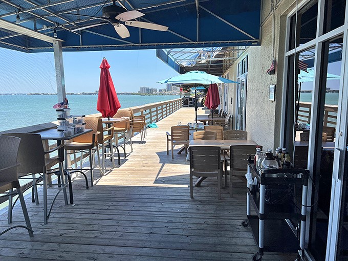 Waterfront dining where the view competes with the food for your attention. Those umbrellas aren't just for shade—they're keeping your breakfast secrets safe.