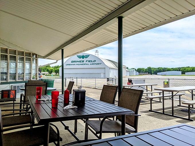 Outdoor seating with a runway view—because pancakes taste even better when accompanied by the occasional Cessna taxiing by.