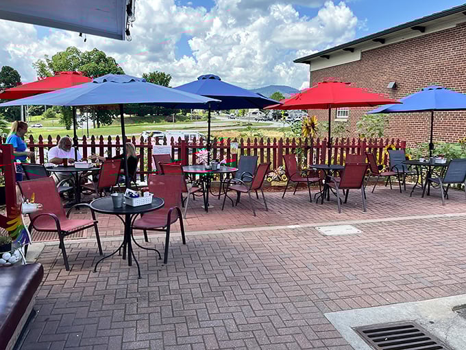 Outdoor seating with mountain views and colorful umbrellas – because sometimes breakfast tastes even better with a side of fresh air.