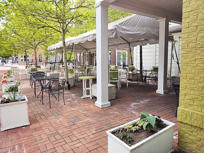 Outdoor seating that captures Pennsylvania's charm—brick pavers, white planters, and the promise of meals enjoyed under leafy canopies.