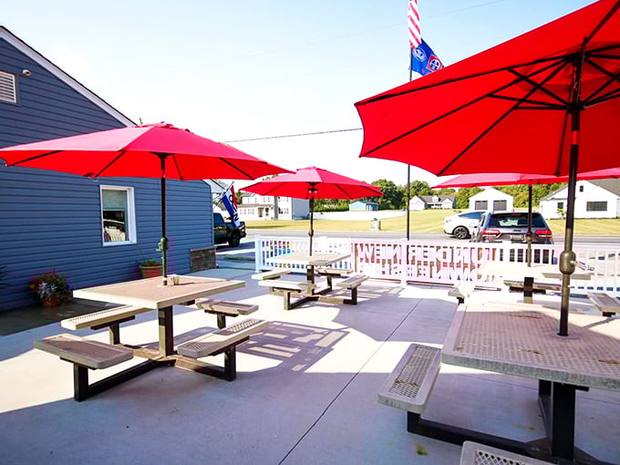 Red umbrellas shade outdoor seating where summer breakfasts taste even better with a side of fresh air and people-watching.