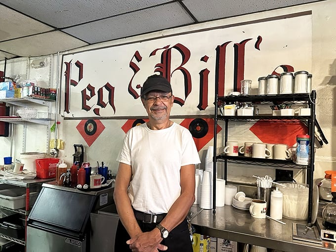The smile behind the spatula—where genuine hospitality isn't corporate policy, it's just how things are done here.