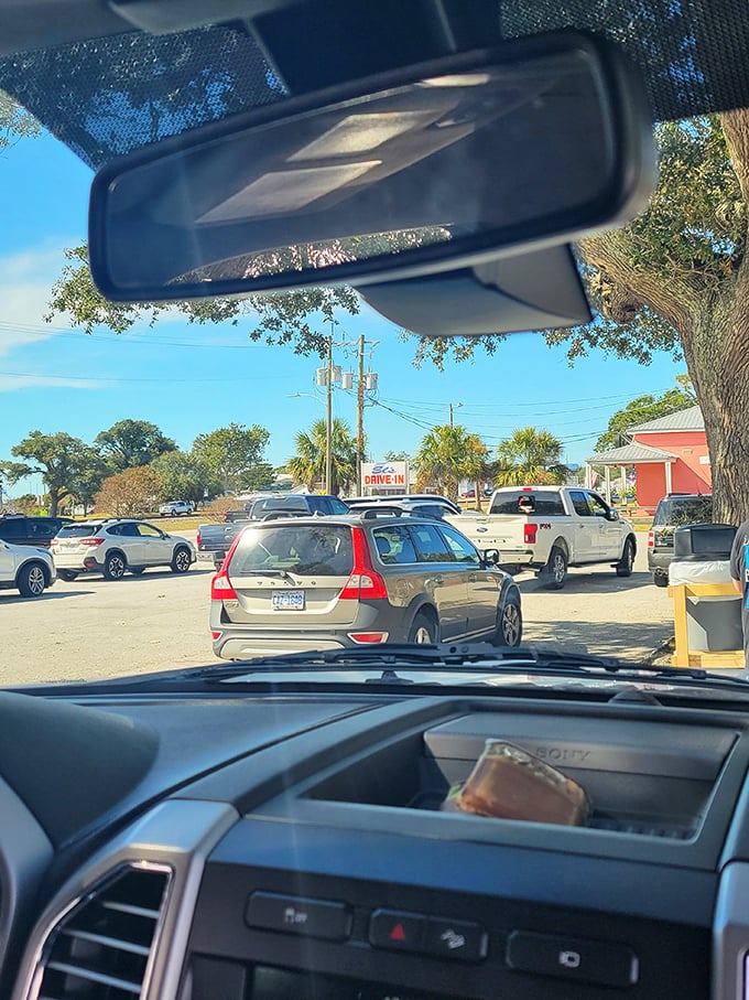 The drive-in experience in full swing. Cars lined up like eager diners at a buffet, waiting for carhop service under Carolina blue skies.