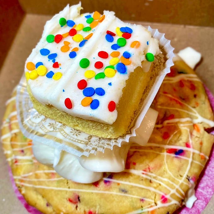 Confetti sprinkles dancing atop vanilla frosting—this cake square brings birthday joy regardless of whether you're celebrating anything beyond making it to the bakery.