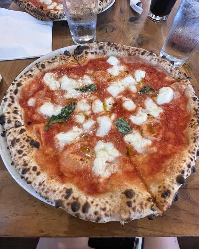 The Pizza Della Casa – where fresh mozzarella melts into bright tomato sauce like old friends reuniting after too long apart.