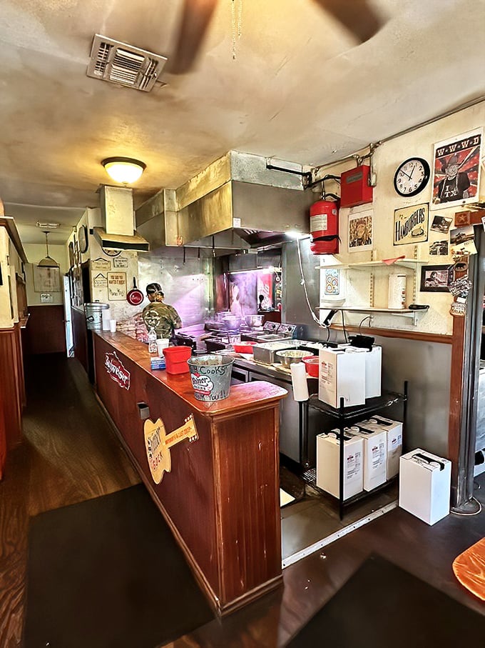 The open kitchen layout means you can watch burger magic happen in real time. That grill has probably seen more action than a Texas football field.