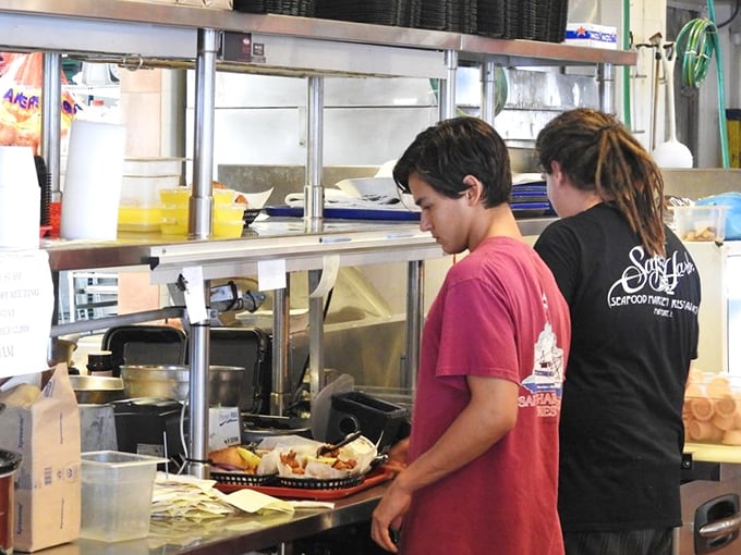 Behind the scenes, where the magic happens – fresh seafood transformed into memorable meals with practiced efficiency.