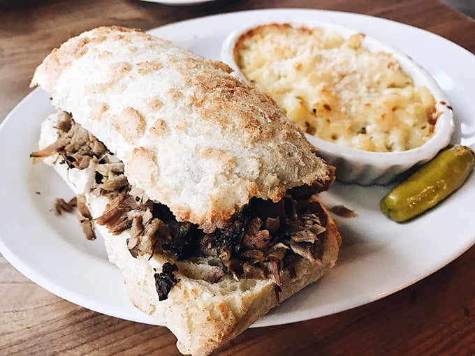 A pulled pork sandwich that doesn't need fancy tricks – just honest smoke, tender meat, and a pickle that knows its supporting role.