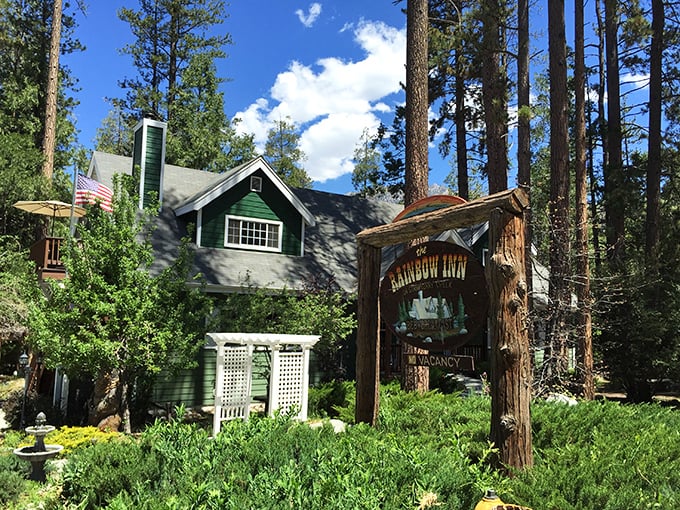 The Rainbow Inn embodies mountain charm with its forest-green trim and rustic wooden sign – the kind of place where check-in comes with stories and local recommendations.