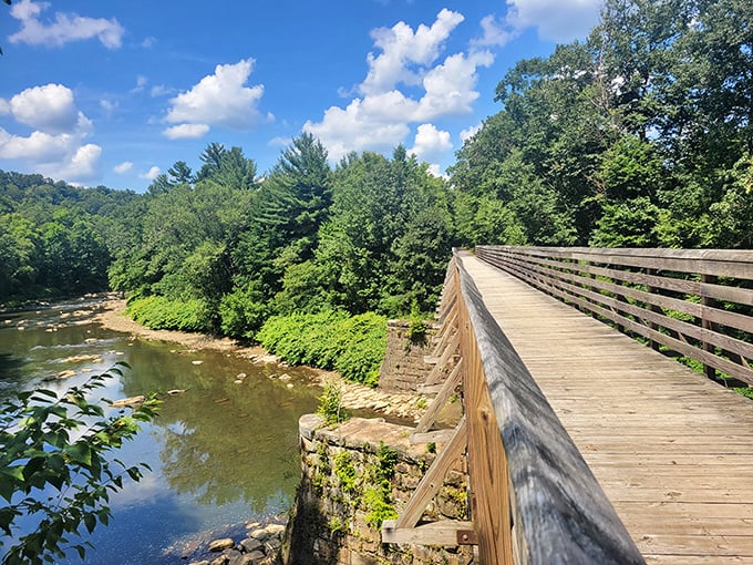 The wooden bridge along Redbank Valley Trail offers both passage and pause—a perfect spot to appreciate Pennsylvania's pristine waterways.