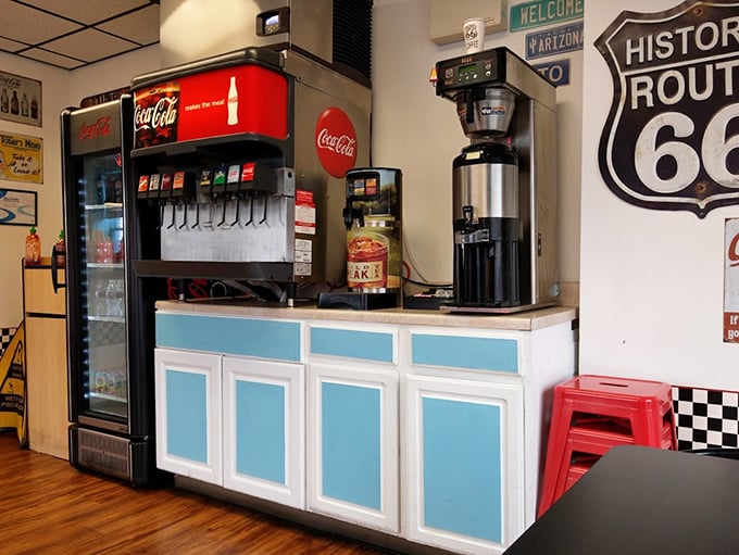 That classic Coca-Cola machine stands ready to dispense the perfect companion to your burger feast—some traditions never need updating.