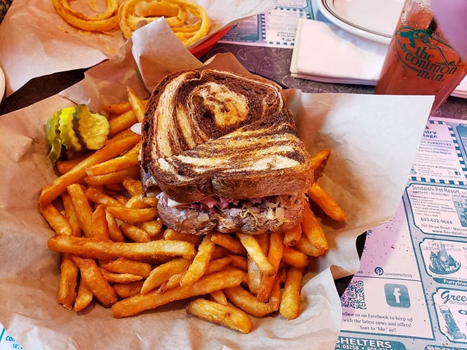 Sandwich architecture at its finest—grilled marble rye supporting the perfect balance of meat, cheese, and fries that deserve their own spotlight.
