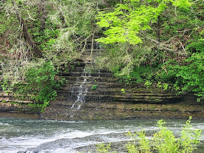 The gentle cascades upstream offer a soothing prelude to the main event – nature's version of an opening act that deserves its own spotlight.