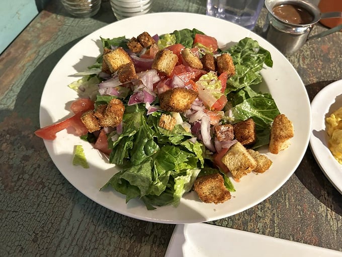Fresh salads remind us that even indulgent breakfast joints know how to balance indulgence with lighter, vibrant options.