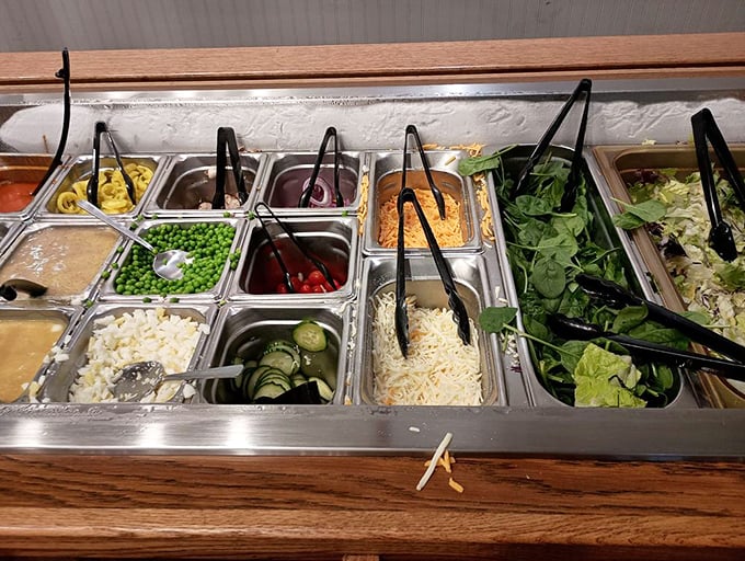 The salad bar—where good intentions meet reality. Those greens are just waiting to share plate space with seventeen other colorful offerings.