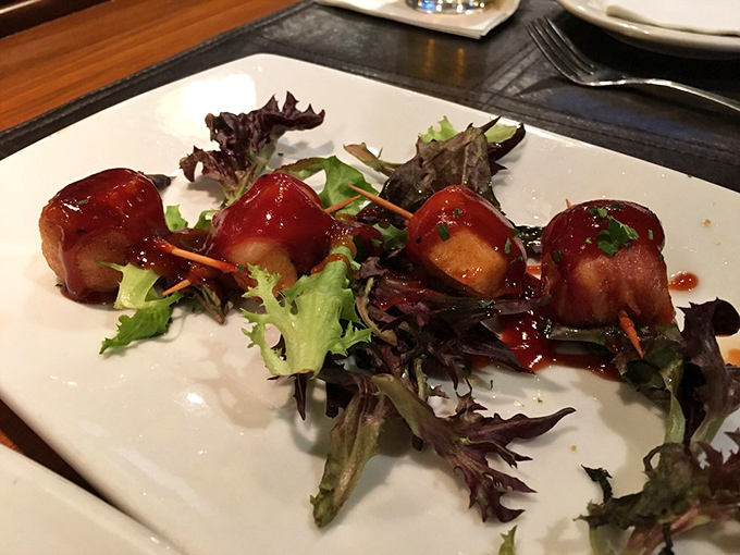 Bacon-wrapped scallops: proof that sometimes the best things in life come in small packages, especially when those packages are wrapped in pork.