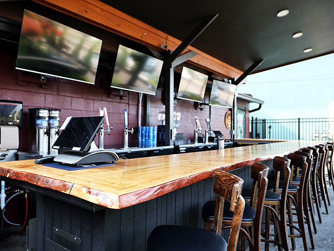 The live-edge wooden bar counter invites elbows and conversations with the natural warmth that no manufactured surface could ever replicate.