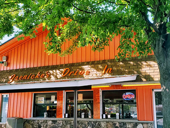 Three perfect ordering windows, framed by stone and that signature orange – the gateway to flavor town that doesn't need a flashy passport.