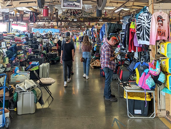 The treasure hunt in progress—shoppers navigating the indoor wilderness of possibilities, each aisle promising undiscovered bargains.